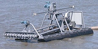 A FLUMP dredges mica from a pigment plant's setttling pond.